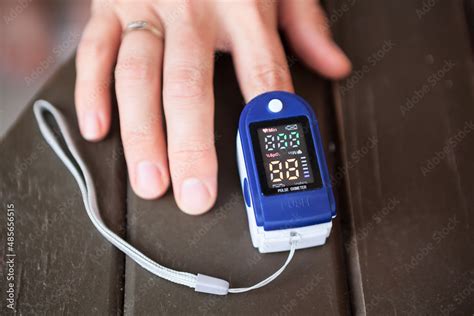 Using Oximeter For Monitoring Peripheral Oxygen Saturation Close Up View Unit Is Attached On