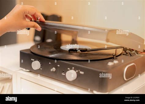 Female Hand Opening The CD Player Machine S Knob And Put On The CD Disc In To The Machine For