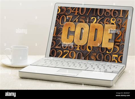 Code Word In Vintage Letterpress Wood Type Against Number Background On A Laptop Computer With A