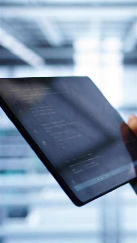 Vertical Programmer Monitoring Server Room Rigs Doing Checkup Inputting Data On Tablet Of