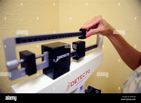 White Woman Uses Balance Scale To Measure Weight Stock Photo Alamy