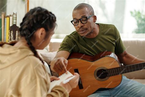 Premium Photo Music Teacher Correcting Mistakes Of Pupil