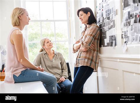 Female Design Team Discussing Ideas At Creative Studio Meeting Stock Photo Alamy