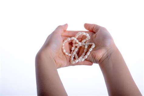 Premium Photo Hand Holding A Necklace