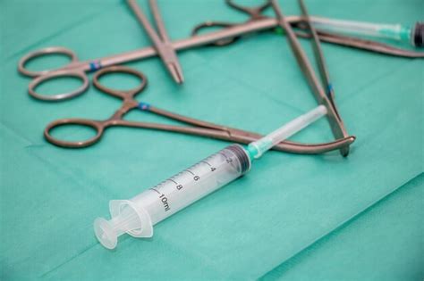 Premium Photo Sterilized Surgical Instrument On Green Fabric Background Surgeon Doctor Tool