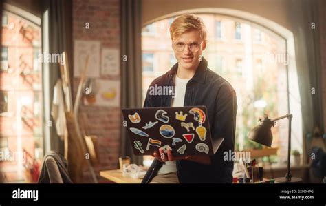 positive male software engineer coding on laptop computer and working