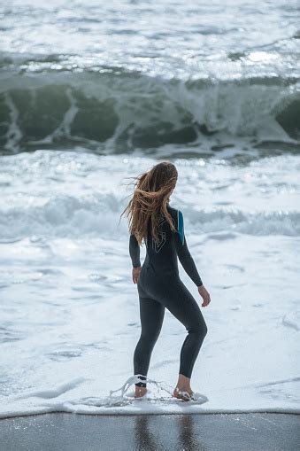 젊은 여 자가 해변에 잠수복을 입고 수영 하기 전에 스트레칭 건강한 생활방식에 대한 스톡 사진 및 기타 이미지 건강한 생활방식 네오프렌 레저 활동 Istock