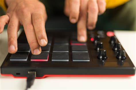 Premium Photo The Hands Of A Man Making Beats On His Mpd Midi Controller