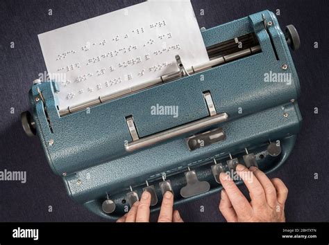 A Woman Typing In Braille Using A Perkins Brailler Typewriter Stock