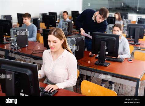 diligent teacher conducts computer science exam in university class