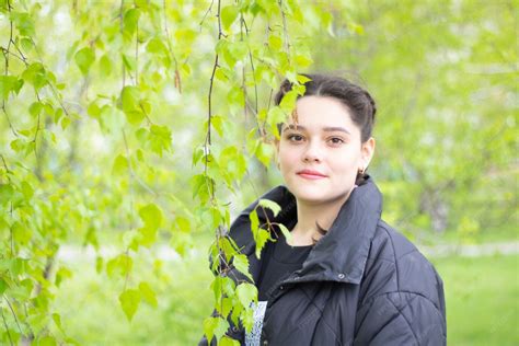 Premium Photo Portrait Of A Young Modest Girl On The Background Of