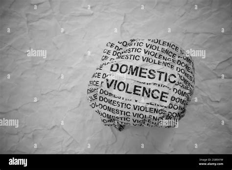Crumpled Paper Ball With Words Domestic Violence On Torn White Paper Pieces Background Stock
