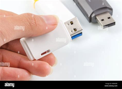 Hand Holding Usb Flash Usb Memory Stick On White Stock Photo Alamy