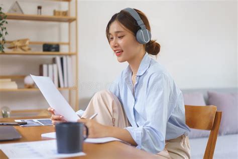 Remote Business Concept Businesswoman Wears Headphone To Meeting And Reading Chart Data