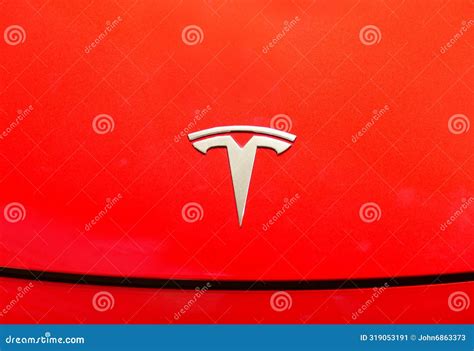 Tesla Logo On Tesla Model 3 Red Background Editorial Photo