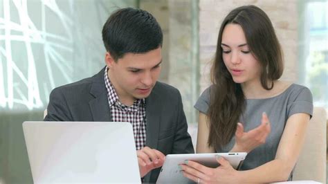 Man And Woman Discussing Collating Data On The Tablet 34772410 Stock