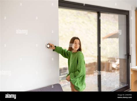 Woman Controlling Temperature With A Smart Thermostat At Modern Apartment Stock Photo Alamy