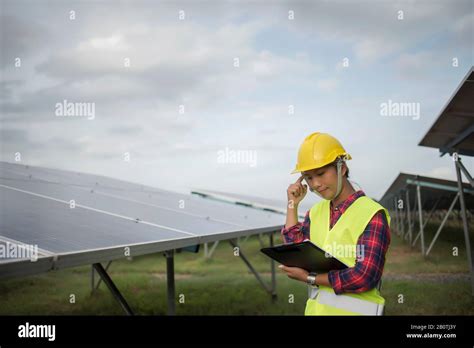 Engineer Electric Woman Checking And Maintenance Of Solar Cells Stock