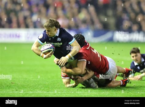 Scotlands Kyle Rowe Tackled By Wales Dafydd Jenkins During The