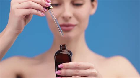 Closeup Woman Applying Facial Serum With Dropper Caring For Skin