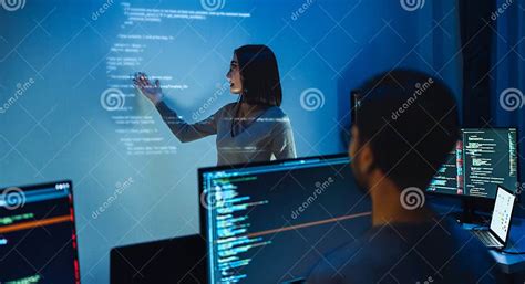 Asian Woman Developers Collaborating On A Coding Project With One Member Pointing At Code