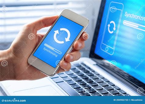 Smartphone Synchronizing Data With Computer For Backup Over Wireless Connection Stock Image