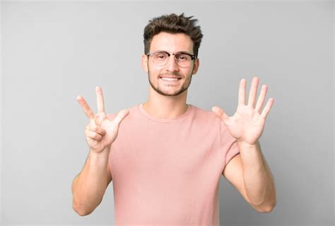 Premium Photo Smiling And Looking Friendly Showing Number Eight Or