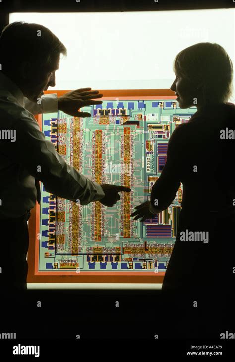 Man And Woman Checking Circuit Drawing For Microprocessor Chip Stock Photo Alamy