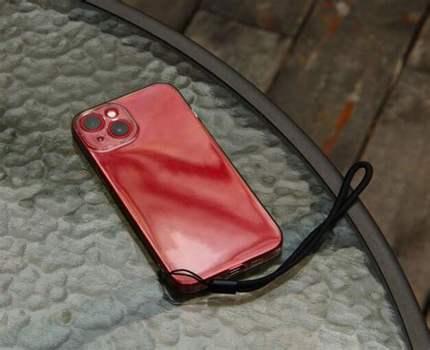 Premium Photo Smartphone In A Red Case On The Edge Of A Glass Table