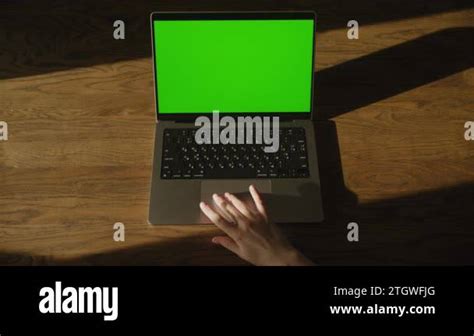 Top View Of A Caucasian Woman Hand Entering The Frame And Swiping On A Laptop Computer Touchpad