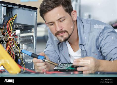 Handsome Man Soldering A Circuit Board Stock Photo Alamy