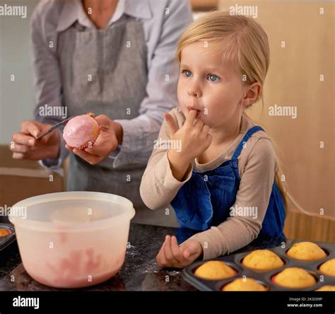 Finger Licking Good Icing A Mother And Her Two Daughters Baking At