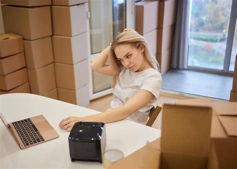 Premium Photo Young Blonde Woman Barcode Printer And Boxes On The