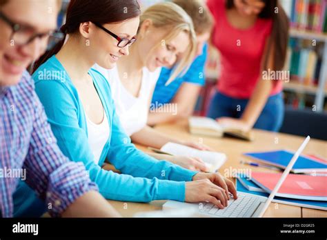 Portrait Of Pretty Girl Typing On Laptop Among Her Group Mates At Lesson Stock Photo Alamy