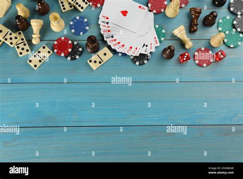 Elements Of Different Board Games On Light Blue Wooden Table Flat Lay Space For Text Stock