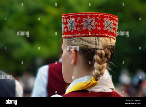 A Young Woman In A Traditional Latvian Folk Attire She Wears A Colorful Headdress Her