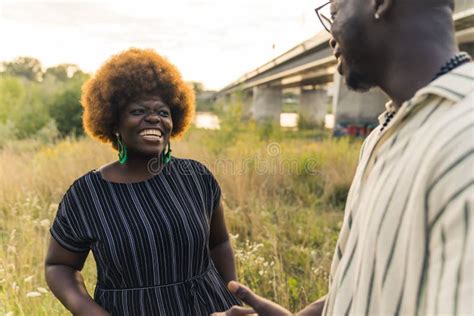 Smiling Ethnic Dark Skinned Straight Couple Having A Relaxing Summer Evening Talking Laughing