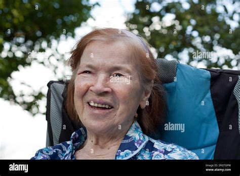 Portrait Of Happy Smiling Senior Grandmother In Garden At Home Old