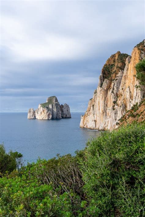 Vertical Landscape Of The Cliffs And Sea Stacks At Porto Flavia On