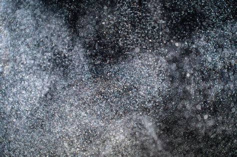 Dust Particles Cloud Generating Abstract Shape On Black Background With Copy Space For Text