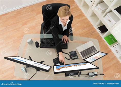 Businesswoman Analyzing Financial Data And Chart On Computer Stock