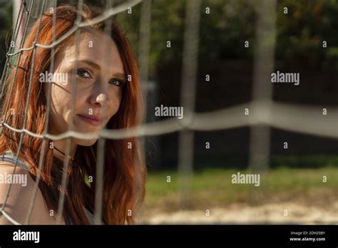 A Gorgeous Redhead Fitness Model Preparing To Play Volleyball Stock Photo Alamy