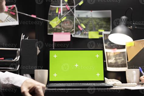 Two Private Detectives Looking At A Green Screen On Laptop In Evidence