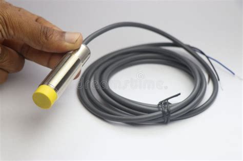 Capacitive Proximity Sensor Used In Distance Detection Held In The Hand On White Background