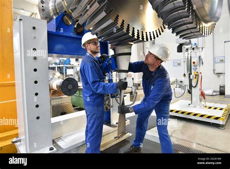 Workers Assembling And Constructing Gas Turbines In A Modern Industrial