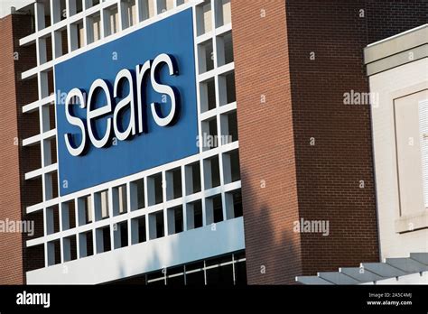 A Logo Sign Outside Of A Sears Retail Store Location In Greensboro