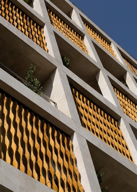 Wavy Wooden Shutters Cover Gridded Apartment Block In Iran