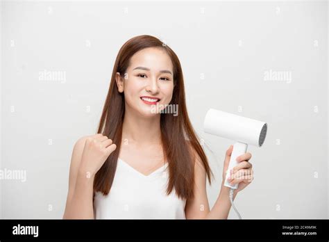 Beautiful Asian Girl Drying Her Hair With Hairdryer Stock Photo Alamy