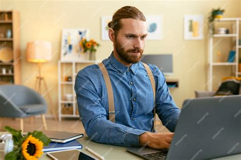 Free Photo Portrait Of Bearded Man Working On Laptop