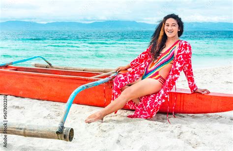 Transgender Woman Posing In Colorful Swimwearon A Boatwhite Beach